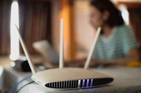 Premium Photo A Woman Is Working At Home Using A Modem Router Connecting The Internet To Her