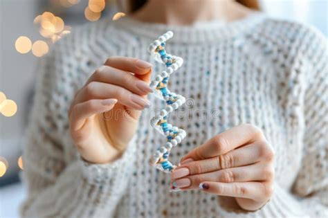 Cozy Sweater And Hands Manipulating A Silver Dna Helix Representing