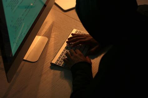 premium photo hacker with computer and laptop