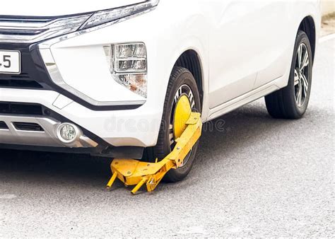 Photo Of A Car Wheel Lock With A Yellow Mount Device For Preventing