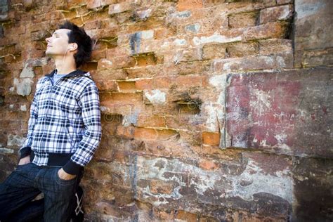 Man Leaning Against Wall Stock Photo Image Of Male Jeans