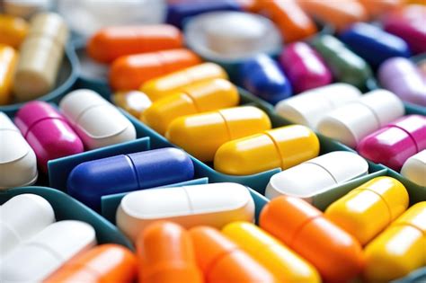 premium photo a pile of various colorcoded pill boxes