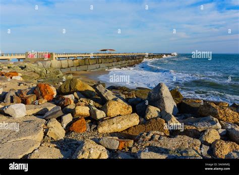 Wide Angle View Of Cabrillo Beach Pier With Rocky Shoreline Gentle