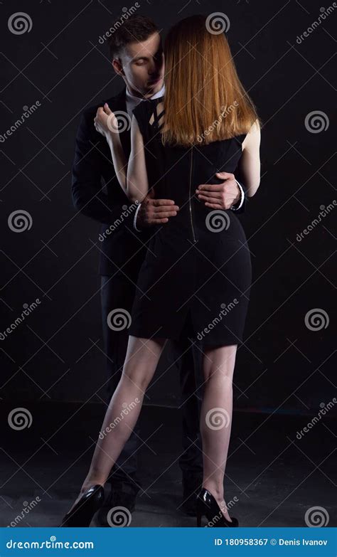 A Young Couple Gently Embraces Before Kissing A Man In A Formal Suit