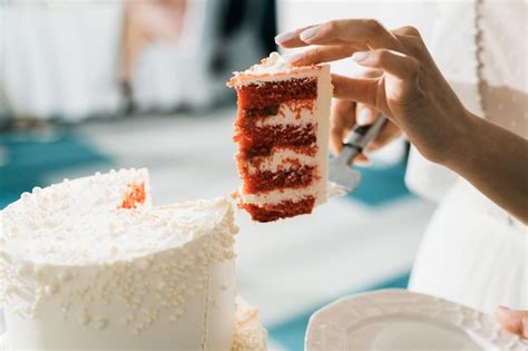 Premium Photo Bride Cuts First Piece Of Wedding Cake