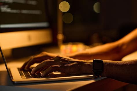 Premium Photo Closeup Of Young Programmer Sitting At Table And Typing