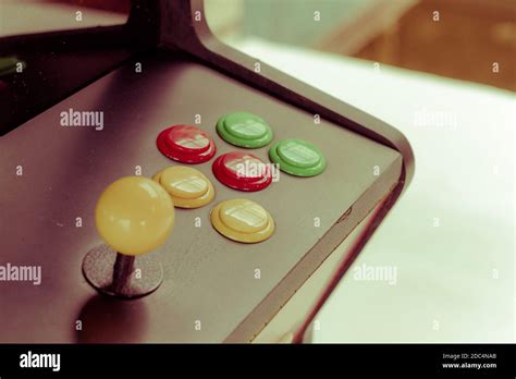 Yellow Joystick Of An Old Arcade Video Game With Six Colorful Button Retro Filter Focusing On