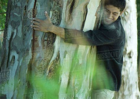 Man Hugging Tree Smiling Eyes Closed Stock Photo Dissolve