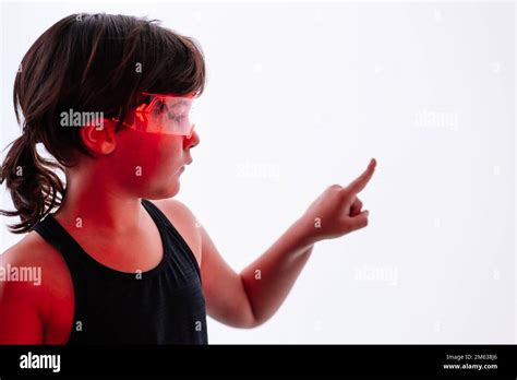 Adorable Girl In Red Digital Glasses With Dark Hair Touching Invisible Objects In Cyberspace