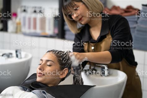 Beautiful Caucasian Women Feel Relax And Comfortable While Getting Hair Wash With Shampoo And