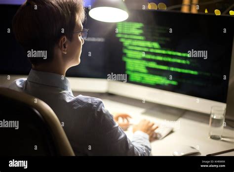 Unrecognizable Programmer With Short Haircut Making Necessary Corrections In Brand New Computer