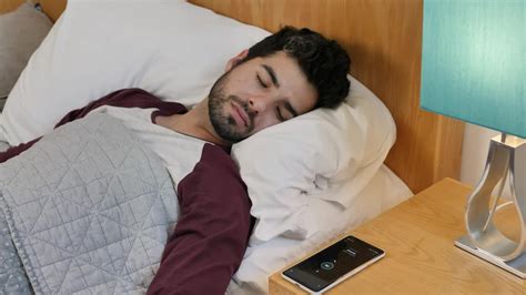 Free Video Stock Sleeping Man Is Awakened By His Cell Phone Alarm Live