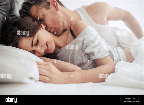 Romantic Couple In Bedroom Enjoying Sensual Foreplay Woman Smiling And