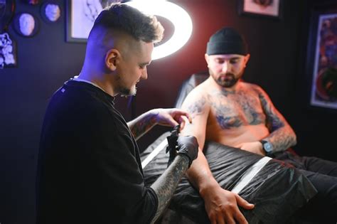 Premium Photo Professional Tattoo Artist Makes A Tattoo