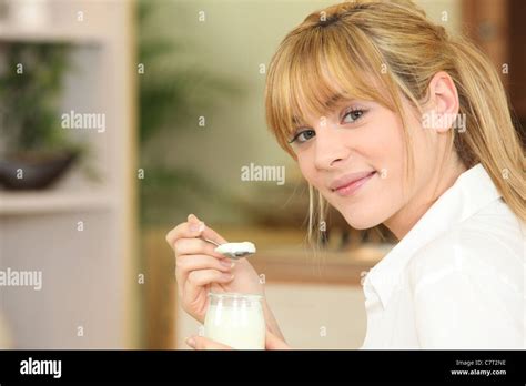 Woman Eating Yoghurt Stock Photo Alamy