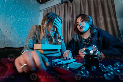 Fortune Teller Forecasting The Future To Woman With Cards Stock Photo At Vecteezy