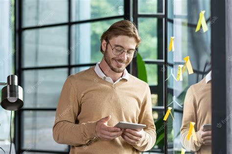 Premium Photo Portrait Of A Young Smiling And Successful Programmer Standing In The Office