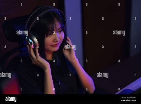 Female Cyber Hacker Gamer In Headphone Watching Video Game On Monitor To Hacking Programming