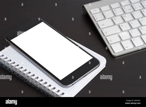 Phone On Notepad On Dark Table And Keyboard Stock Photo Alamy