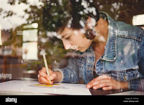 Female Artist Drawing On Paper Seen Through Glass Window Stock Photo Alamy