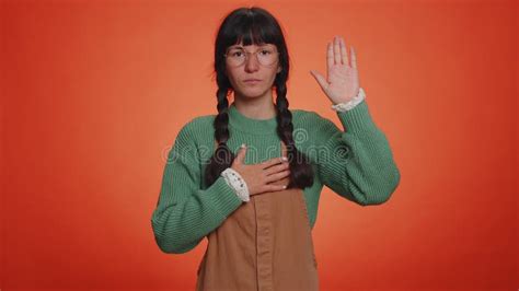 Sincere Responsible Young Nerd Woman Raising Hand To Take Oath
