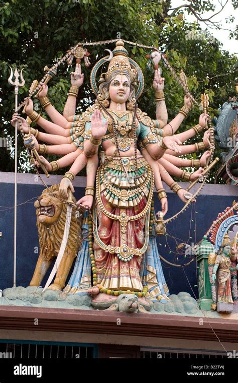 Pavarti A Multi Armed Hindu Goddess Stands On A Temple Roof In Bangalore Her Vehicle Is A