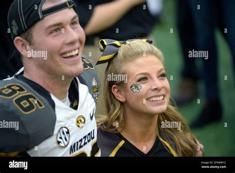 A Missouri Cheerleader Stands With Tight End Jake Hurrell 86 On The
