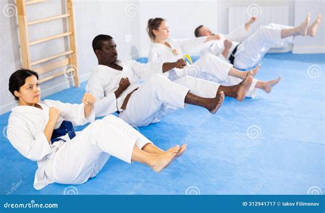 Middle Aged Female Karate Practitioner Training Fist Strikes Lying In