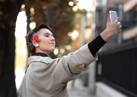Premium Photo Non Binary Person With Modern Hairstyle Taking A Selfie
