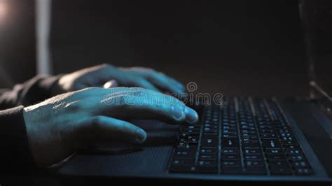 the hacker works on the computer at night the person programmer types