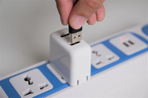 남성 핸드는 배터리를 충전하기 위해 여러 개의 소켓으로 Usb 케이블을 연결합니다 전기 장비 스마트 폰 충전 전선 및 전원 스트립 Usb 케이블에 대한 스톡 사진 및 기타