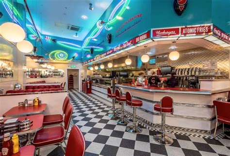 Vintage Diner With Checkered Flooring And Red Chairs Retro Arcade