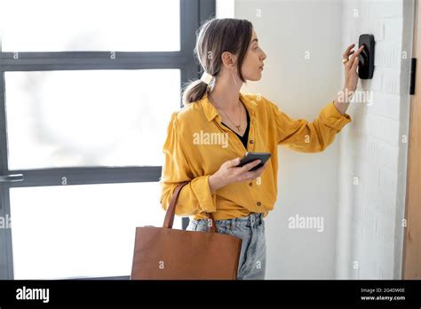 Woman Enters A Code On The Alarm Keyboard At Home Stock Photo Alamy