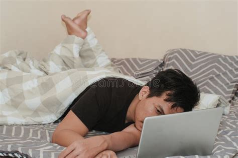 A Southeast Asian Man Watching Movie In Bed Stock Image Image Of Handsome Furniture 334644877