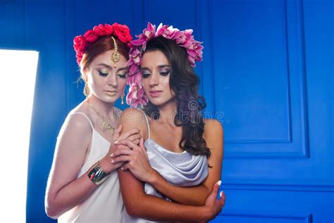 Portrait Of The Two Gorgeous Ladies With Wild Flowers Elegance