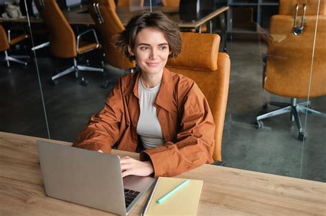 Free Photo Portrait Of Woman Working In Office Sitting At Table With Laptop Girl Programmer