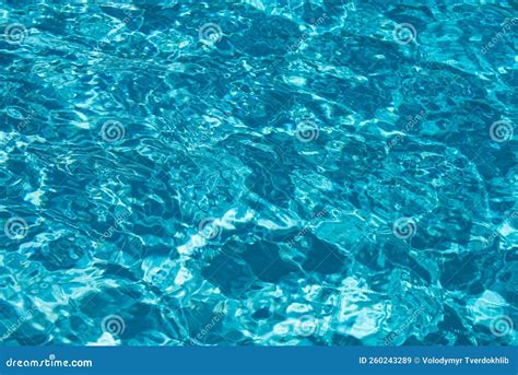 Background Of Blue Water In Swimming Pool With Sun Reflection Ripple