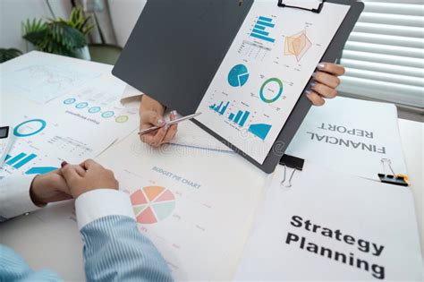 Business Strategy Planning Meeting With Financial Reports And Data Analysis Charts In Modern