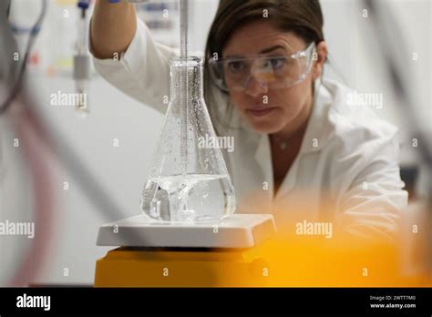 Attractive Female Scientist Testing Using Beaker And Peppet In