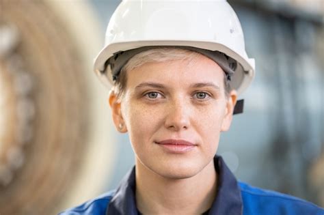 Premium Photo Busy Asian Cnc Operator In Orange Hardhat Working On Control Panel Of Automated