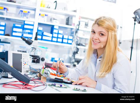 Female Laboratory Assistant Repairs PCB Module For CNC Robotics Measurement Of The Parameters