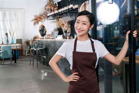 咖啡店门口迎接顾客的女服务员 包图企业站
