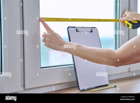 Woman Measuring Window With Tape Measure Tailoring Service Stock Photo Alamy