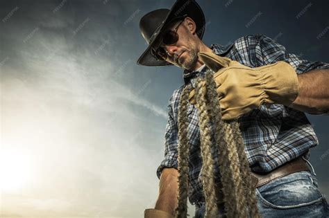 Premium Photo American Cowboy Farmer With A Rope In His Hands