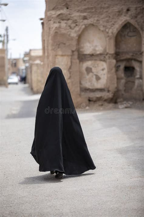 Fully Covered Iranian Lady Walking In A N Old Viallage In Iran Stock