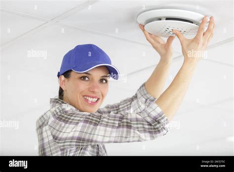 Female Contractor Fitting Ceiling Vent Stock Photo Alamy