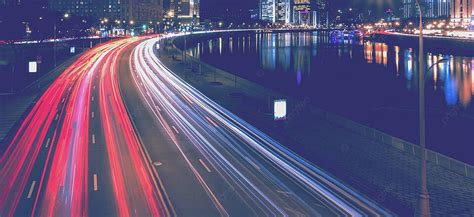 Blurry Lights Trailing Behind A Car In A City During Twilight Photo Background And Picture For
