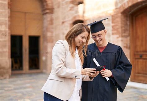 Man And Woman Mother And Son Sitting On Sofa Together At Home Stock