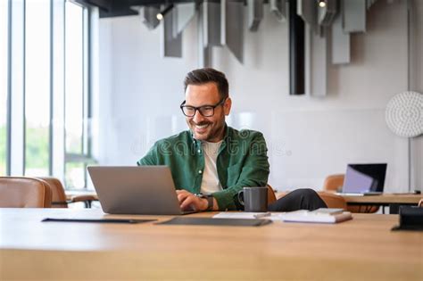 Confident Handsome Programmer In Eyeglasses Developing Software Over