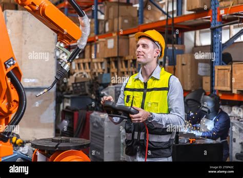 Smart Modern Engineer Male Using Modern Robot Technology Robotic Welding Arm Setup In
